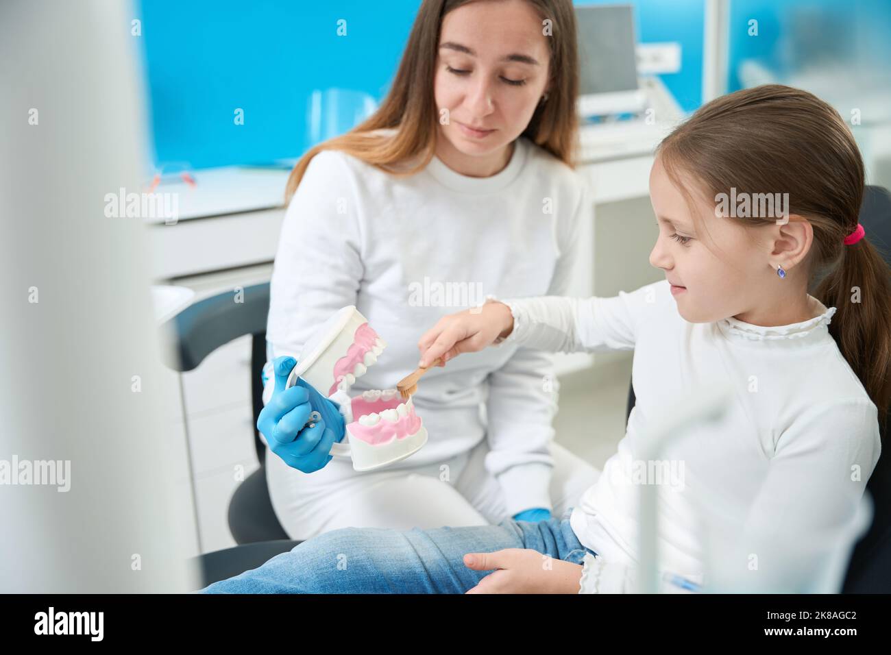 Pre-teen girl learning to clean teeth in dentist office Stock Photo - Alamy