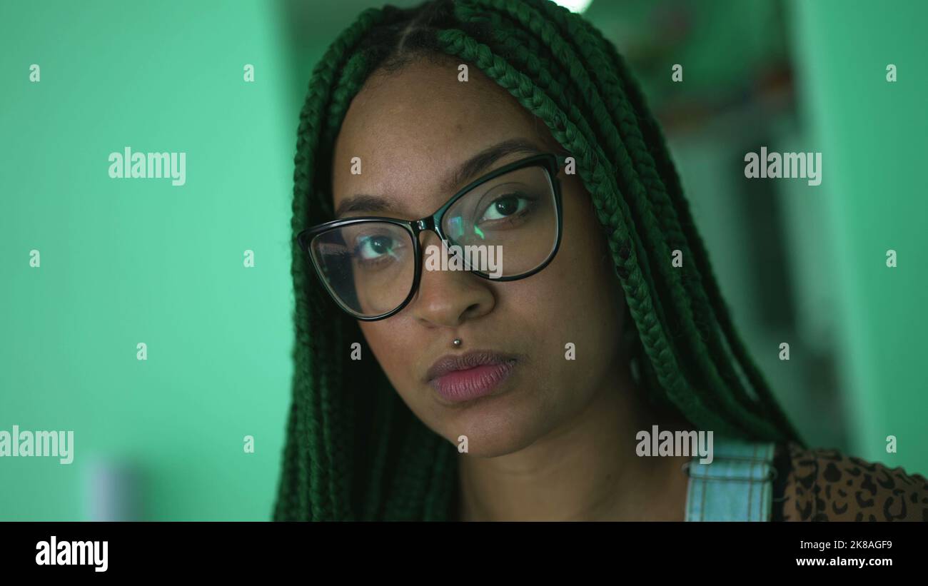 One serious millennial hispanic black girl portrait face looking at ...