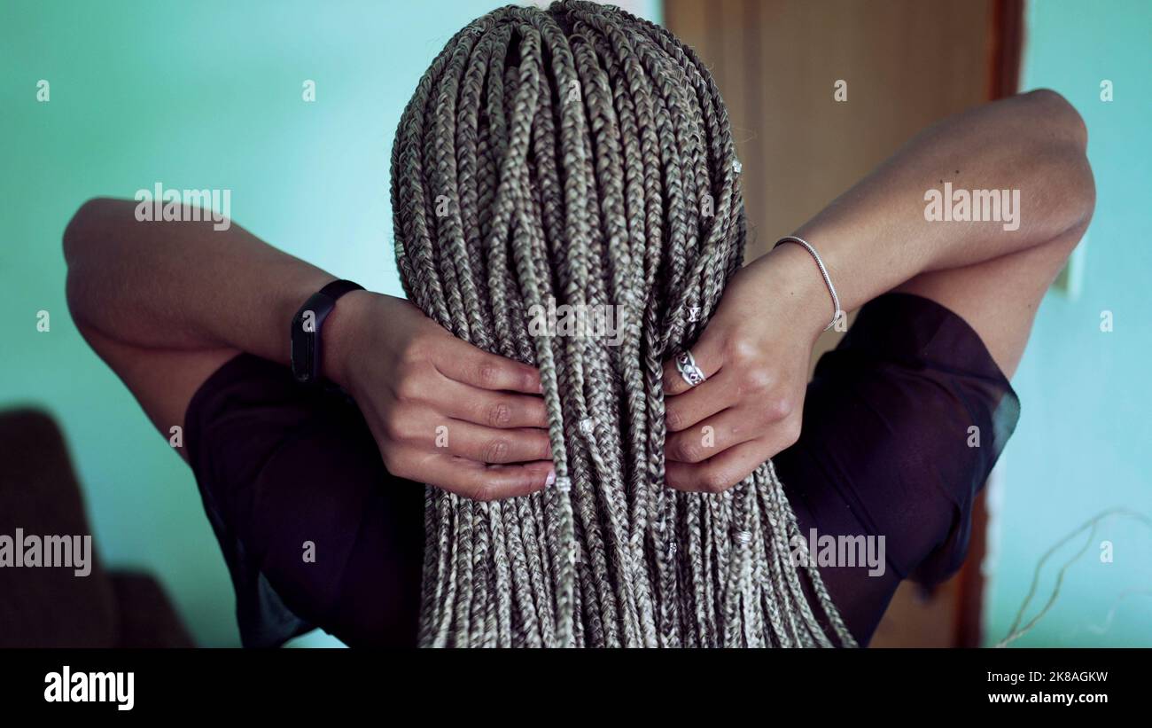 One young latina woman showing her braided hairstyle. Girl shows her ...