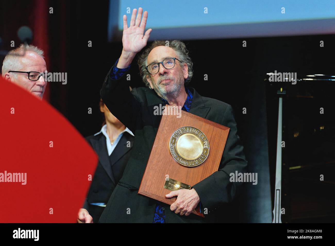 Tim Burton acknowledges the audience onstage the Lumiere Award ceremony ...