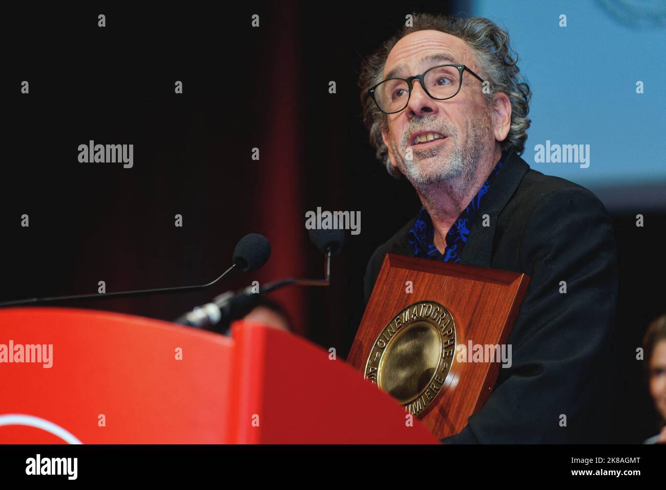 Tim Burton acknowledges the audience onstage the Lumiere Award ceremony ...