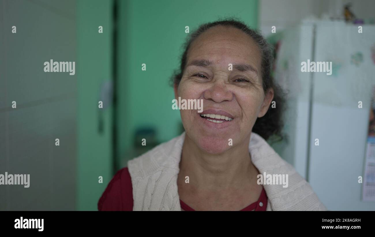 Portrait of a senior hispanic woman smiling at camera. A Brazilian ...