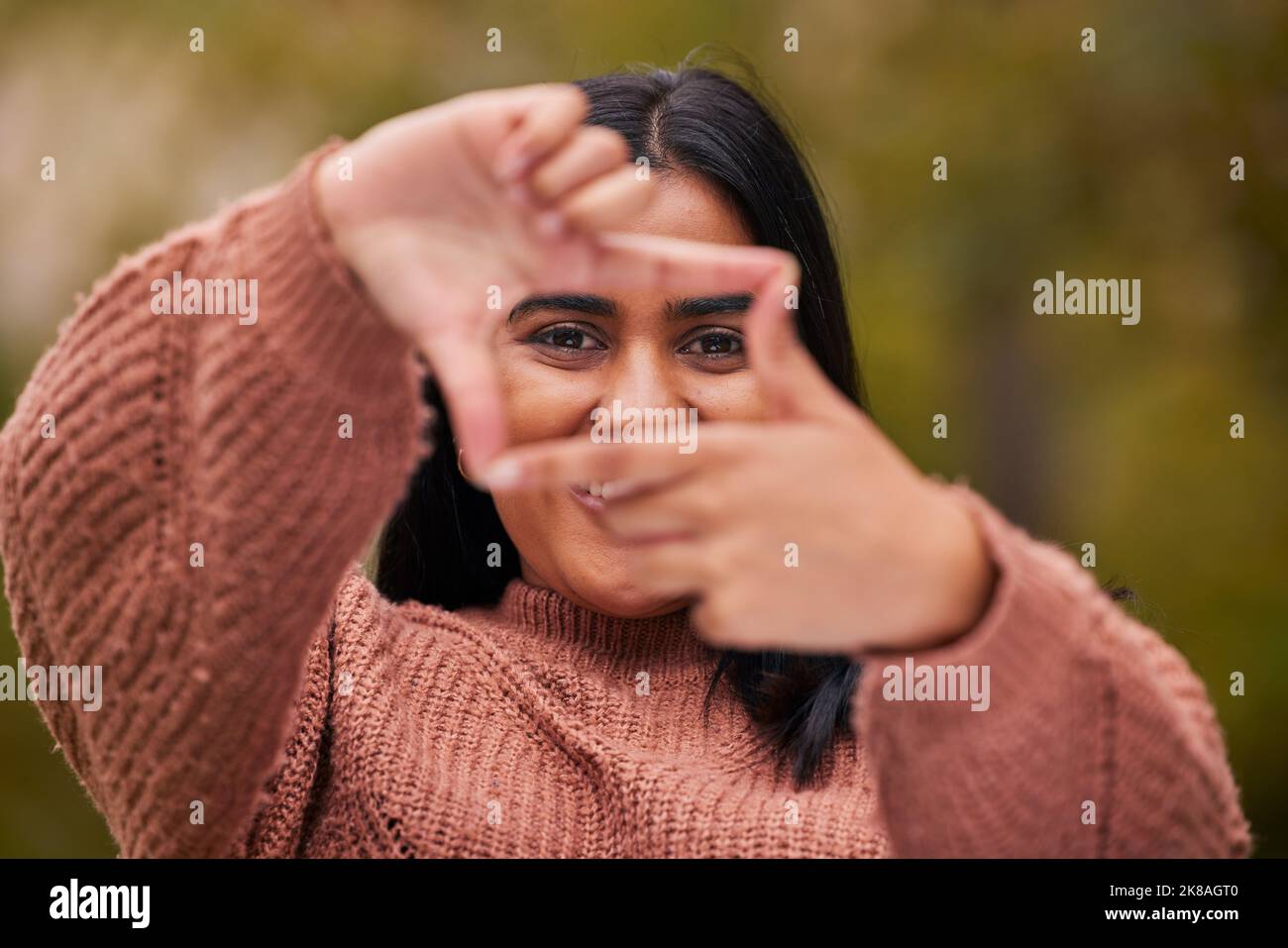 Hands frame, woman and eyes look through fingers while framing happy ...