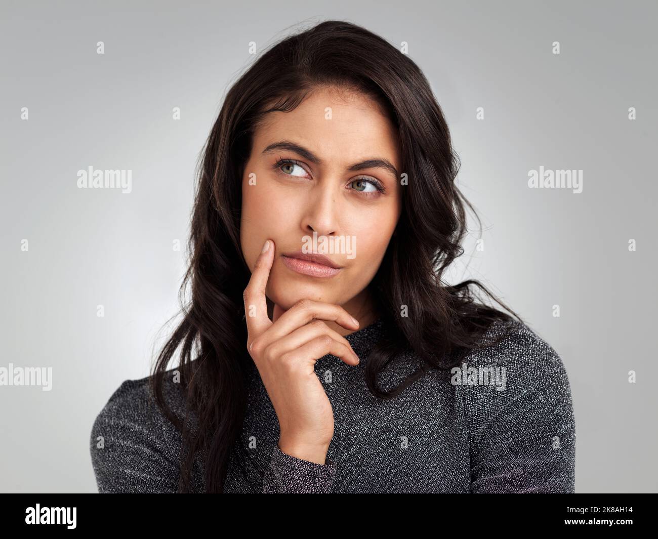 Thats intriguing...a beautiful young woman looking thoughtful while ...