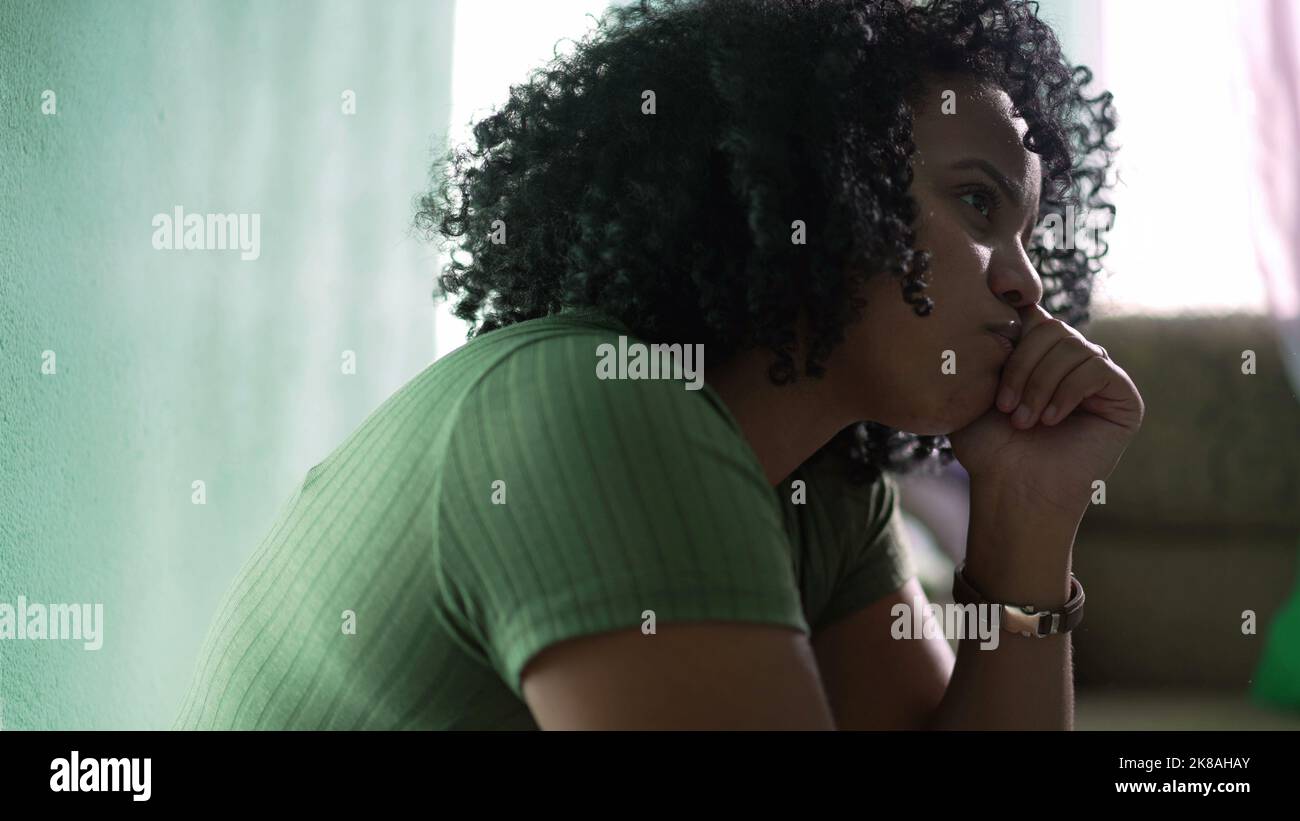 A black woman having doubt feeling uncertainty about the future. An ...