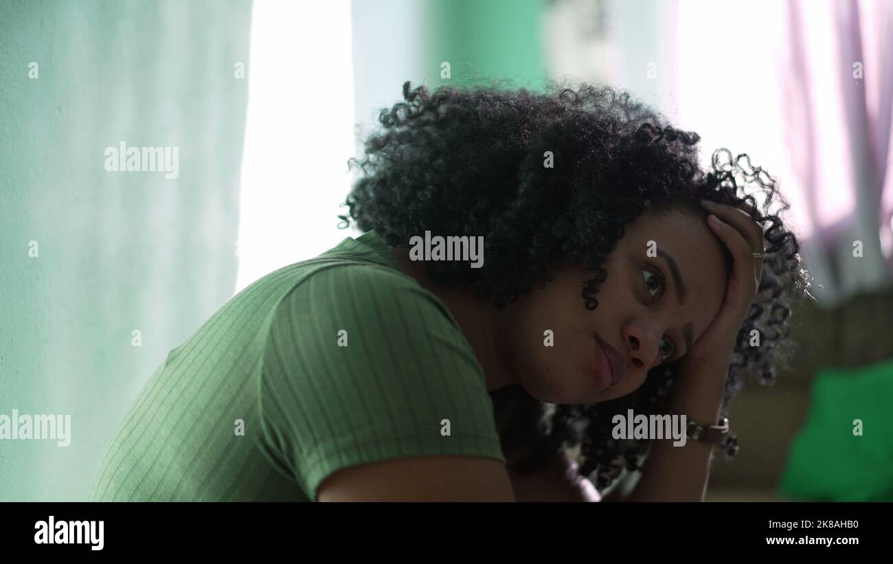 A black woman having doubt feeling uncertainty about the future. An ...