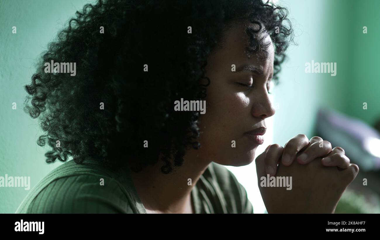 A spiritual African Woman opening eyes to sky in prayer having HOPE ...