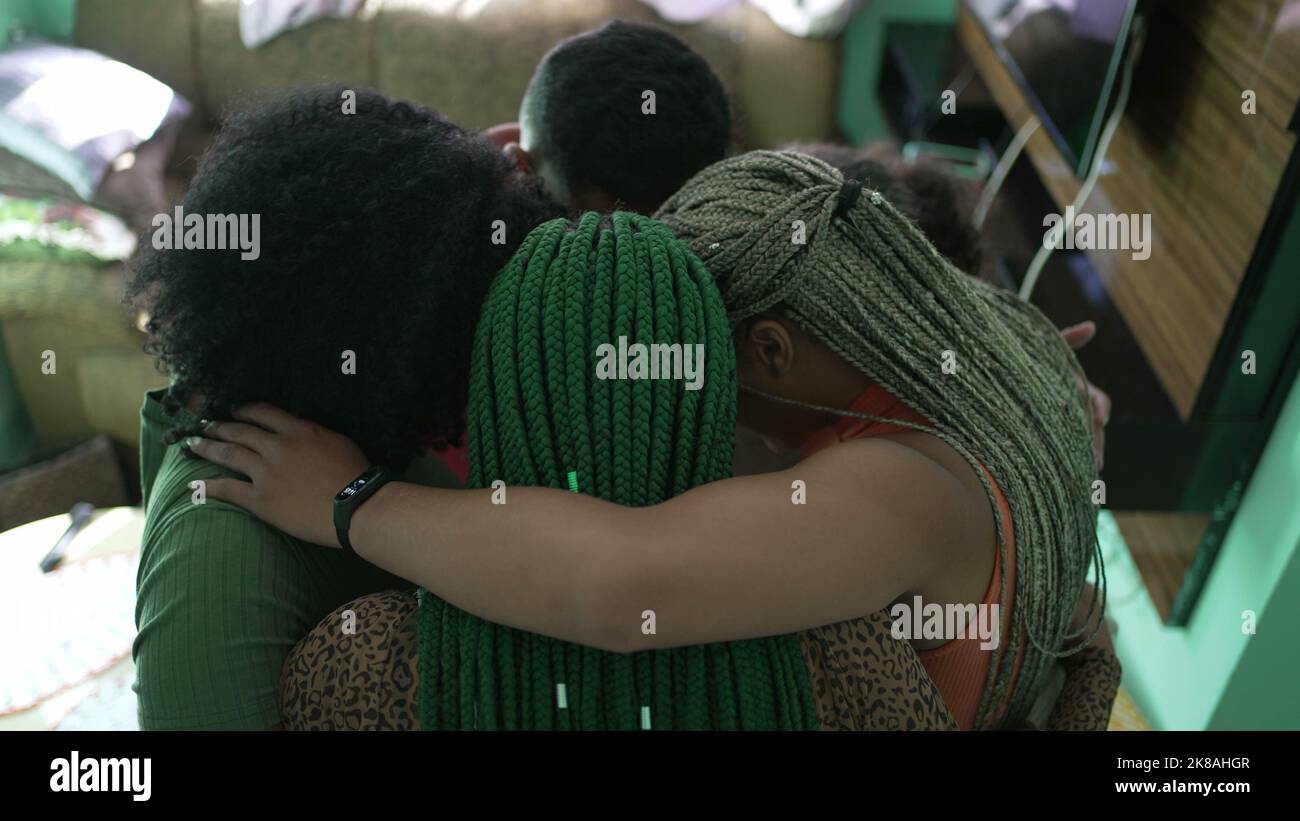 African American family hugging each other at home. A hispanic South ...