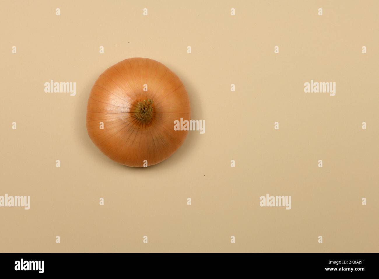 Yellow onion bulbs on beige background. High resolution photo. Full ...