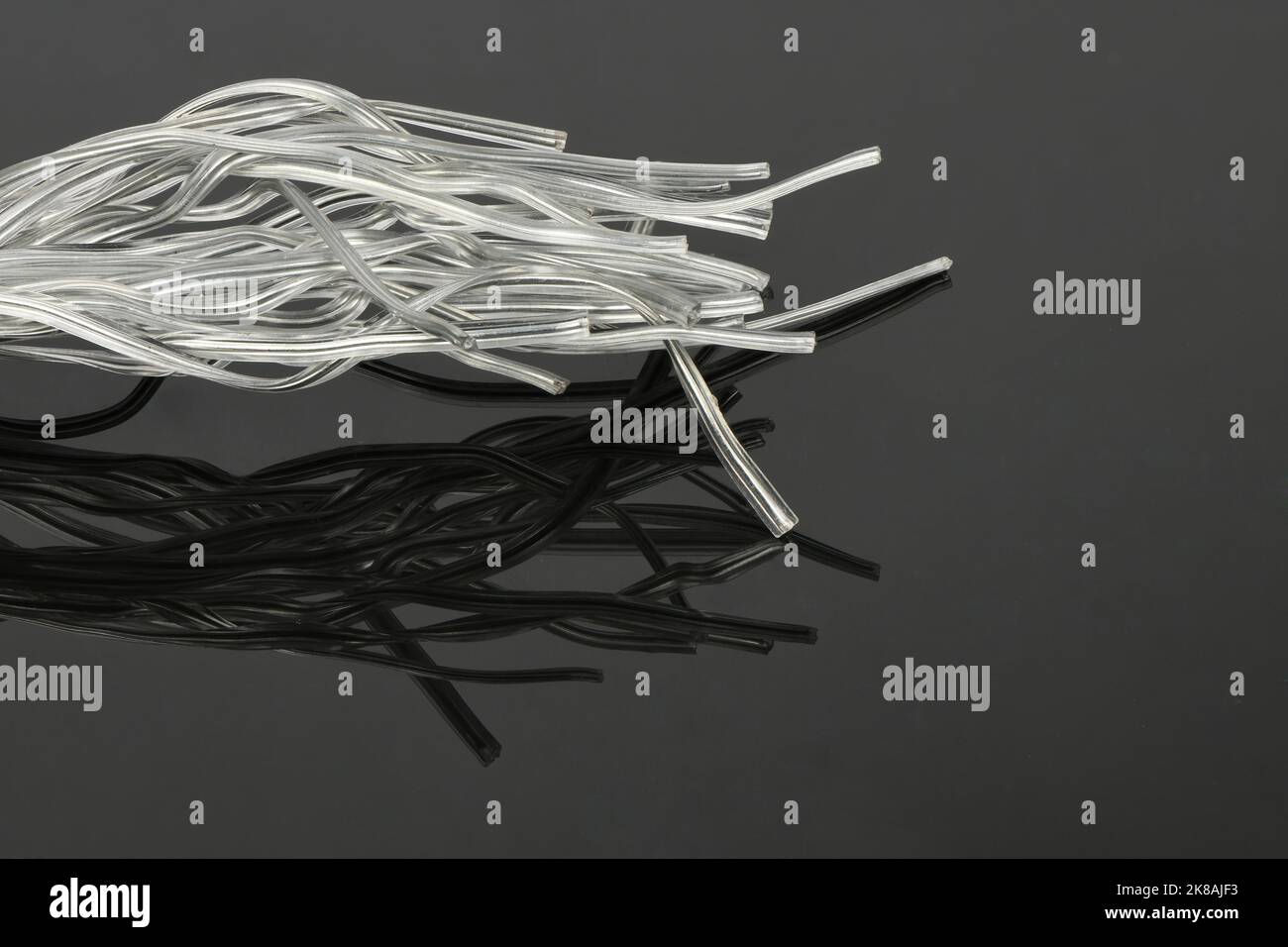 White plastic coated wire tie used for a variety of things on black ...