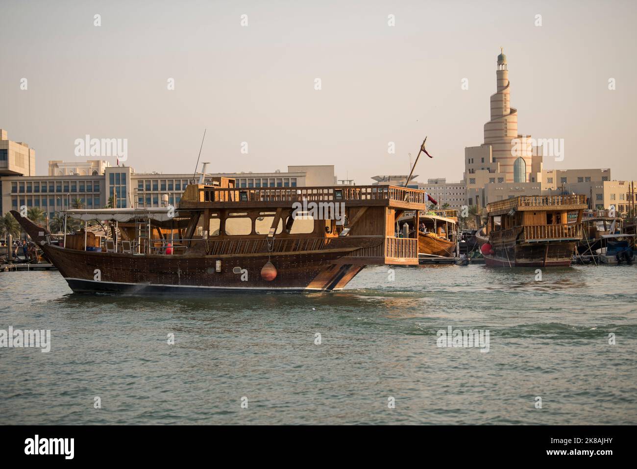 Doha,Qatar- April 24,2022 Traditional boats called Dhows are anchored ...