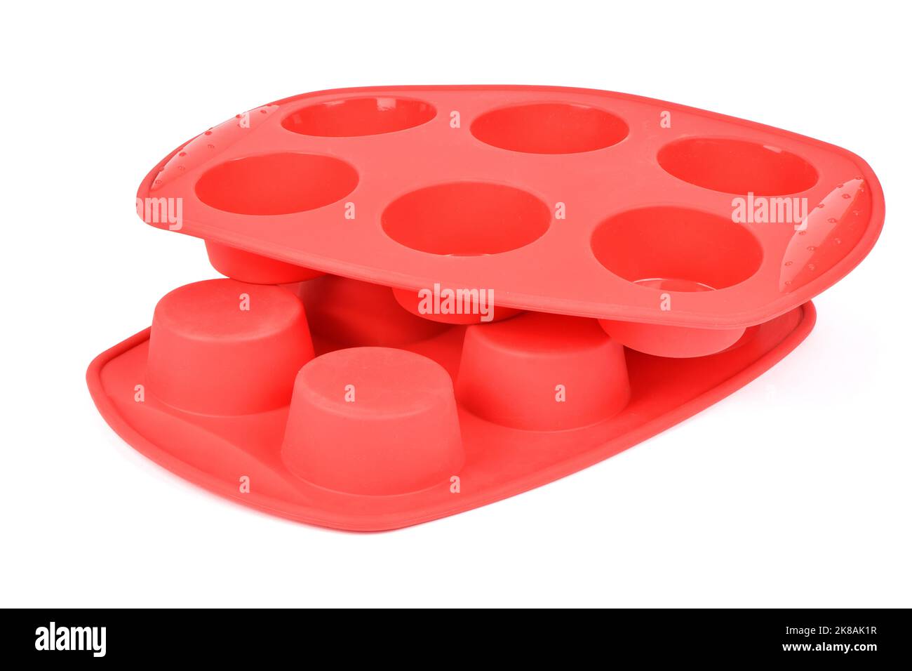 Red silicone form for cooking muffin and cupcake on white background ...