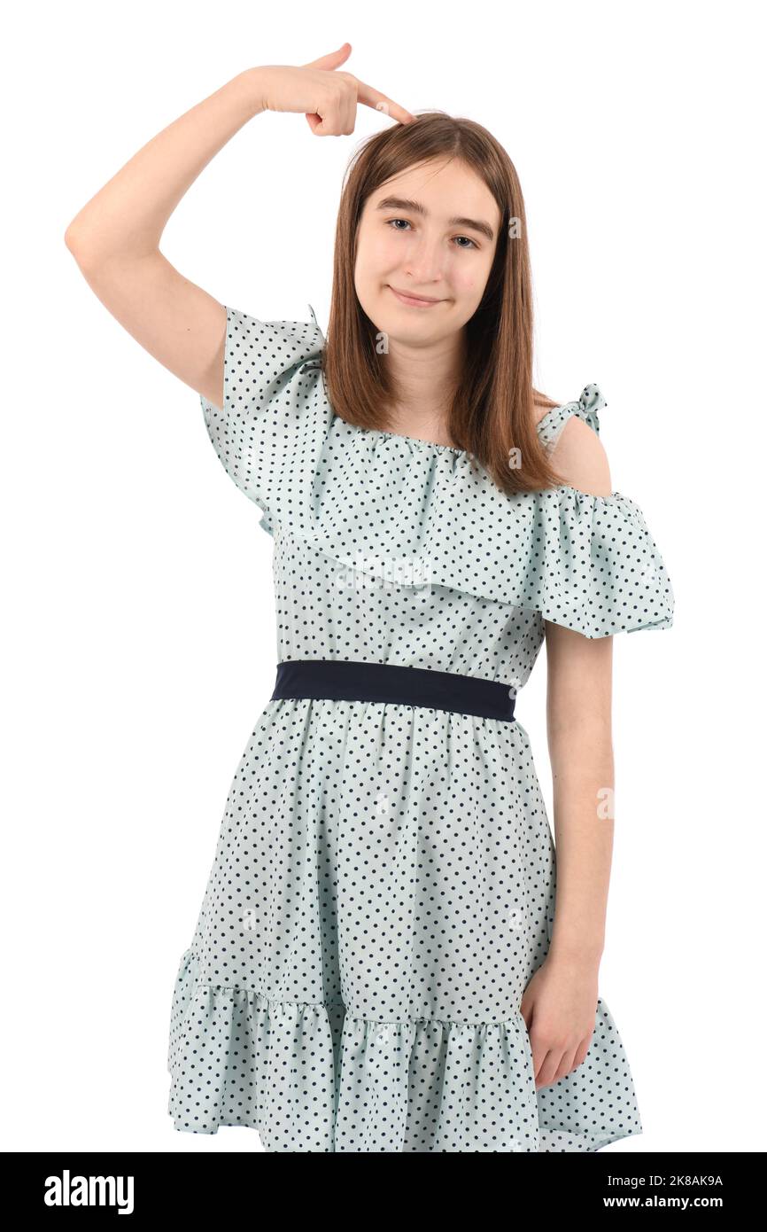 Young beautiful girl in a blue dress with polka dots on a white ...