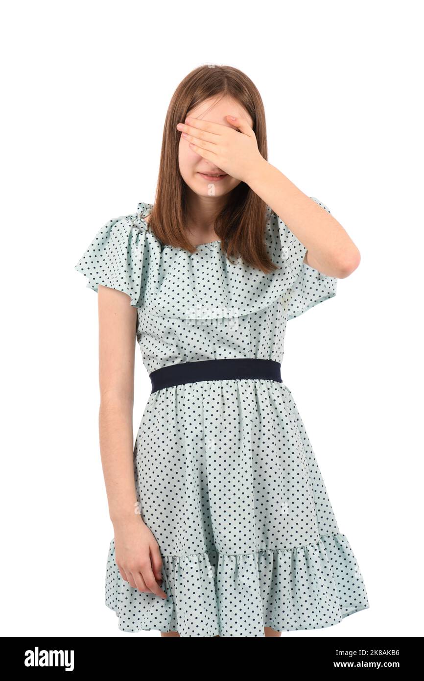 Young beautiful girl in a blue dress with polka dots on a white ...
