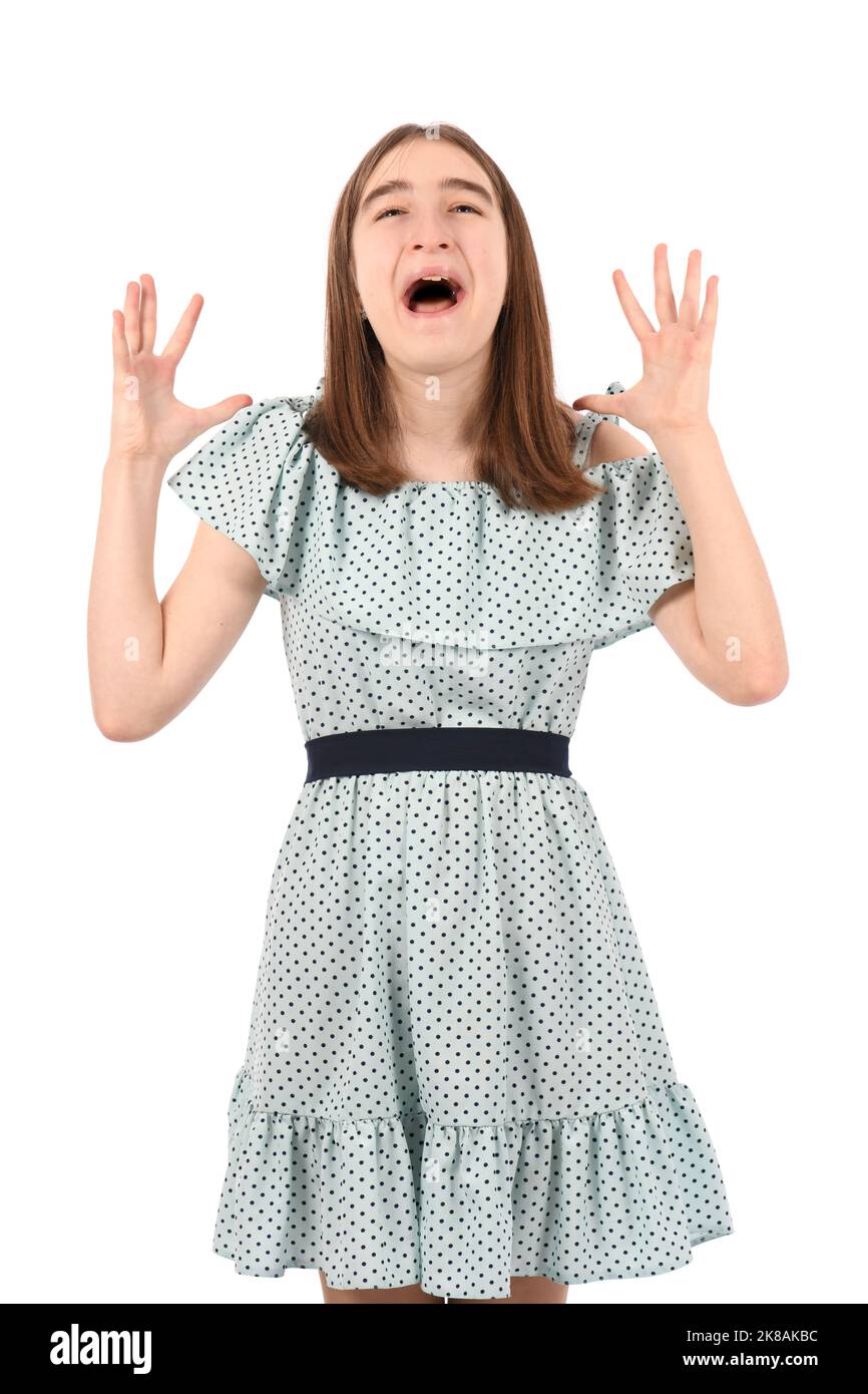 Young beautiful girl in a blue dress with polka dots on a white ...