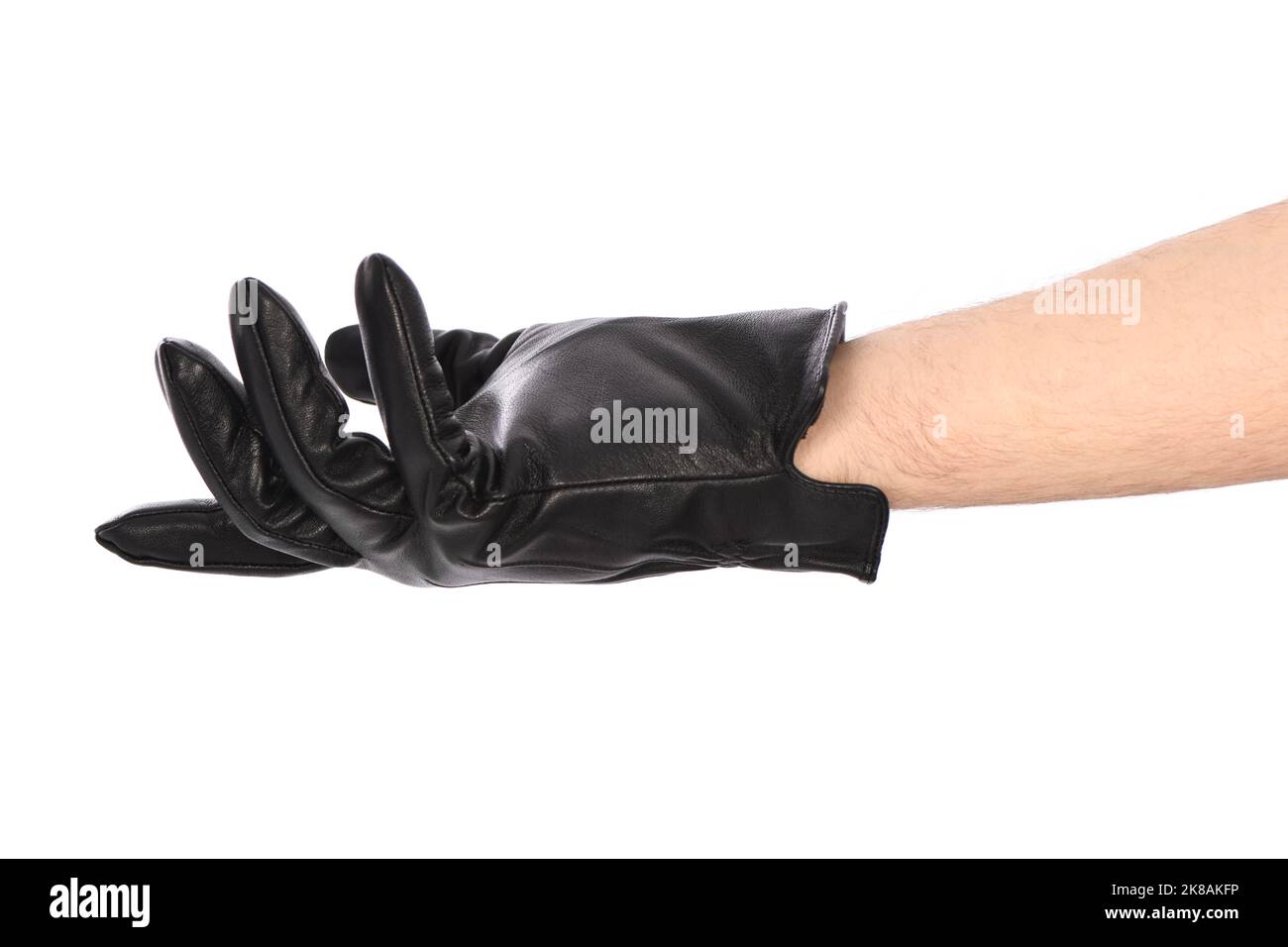 Man wearing black leather glove on white background, closeup. Side view ...