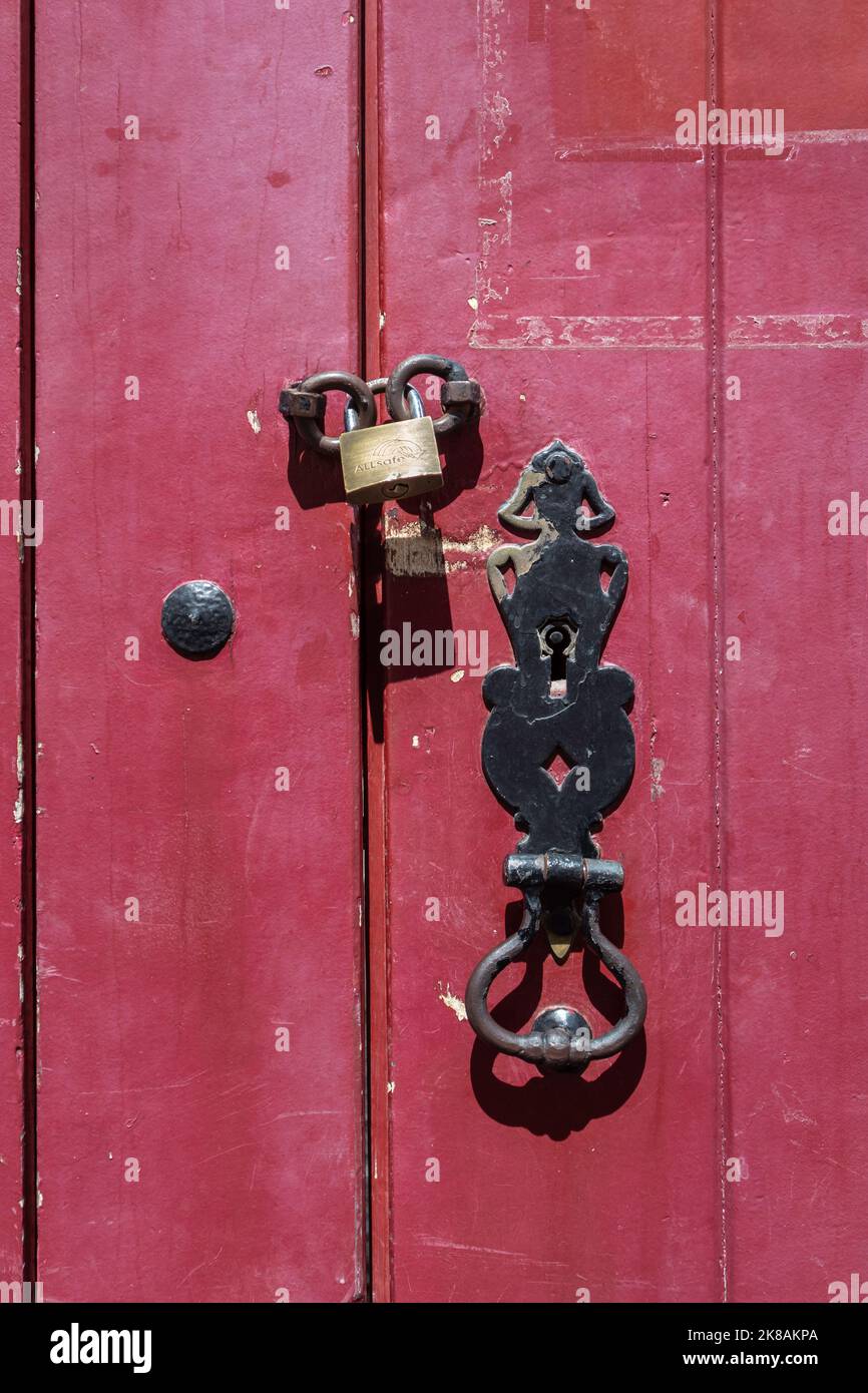 Portugal, August 2022: Old lock on a red wooden door, Algarve, Portugal ...