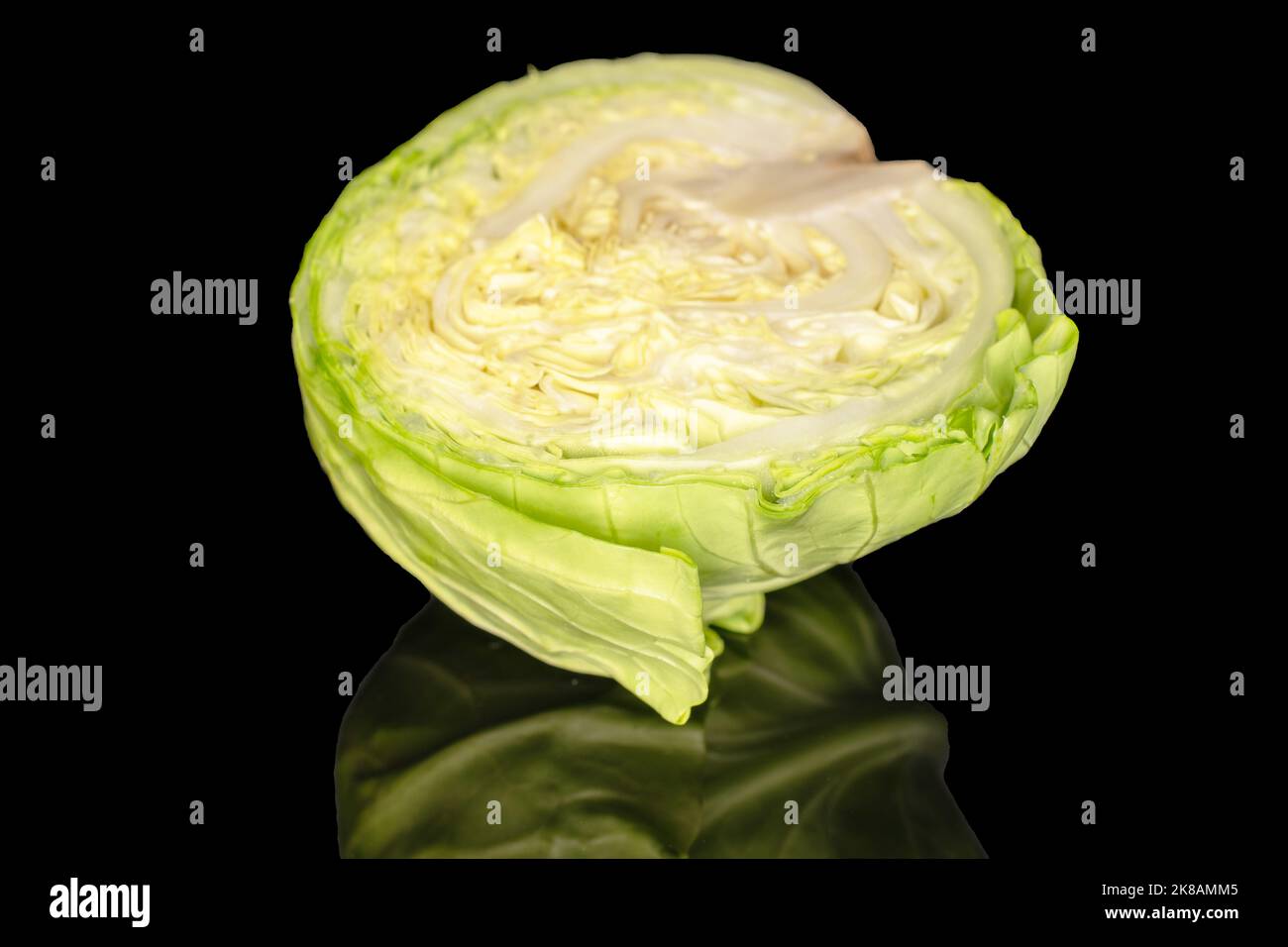 One half head of fresh cabbage, macro, isolated on black background ...