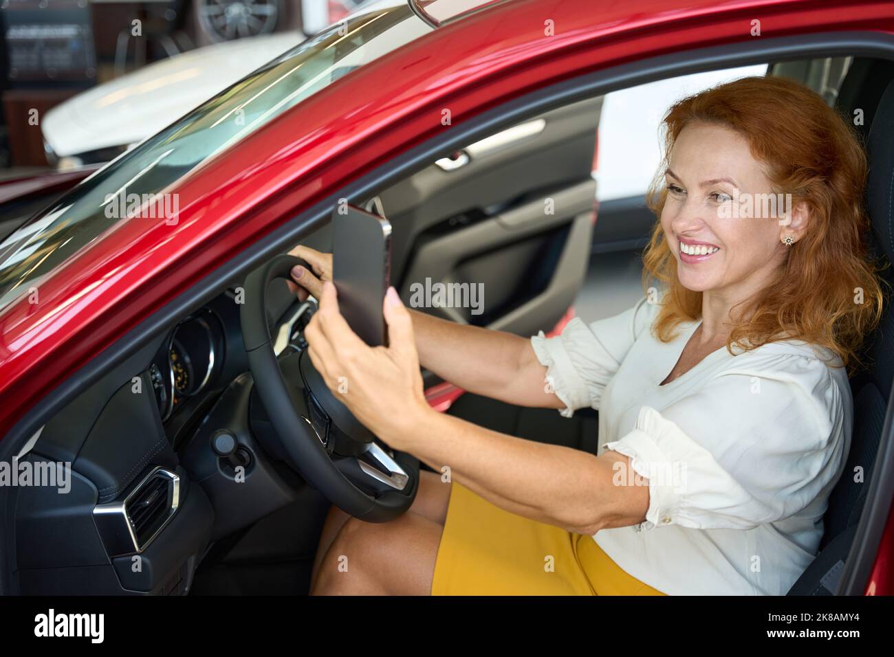 Female person planning to buy car in salon Stock Photo - Alamy
