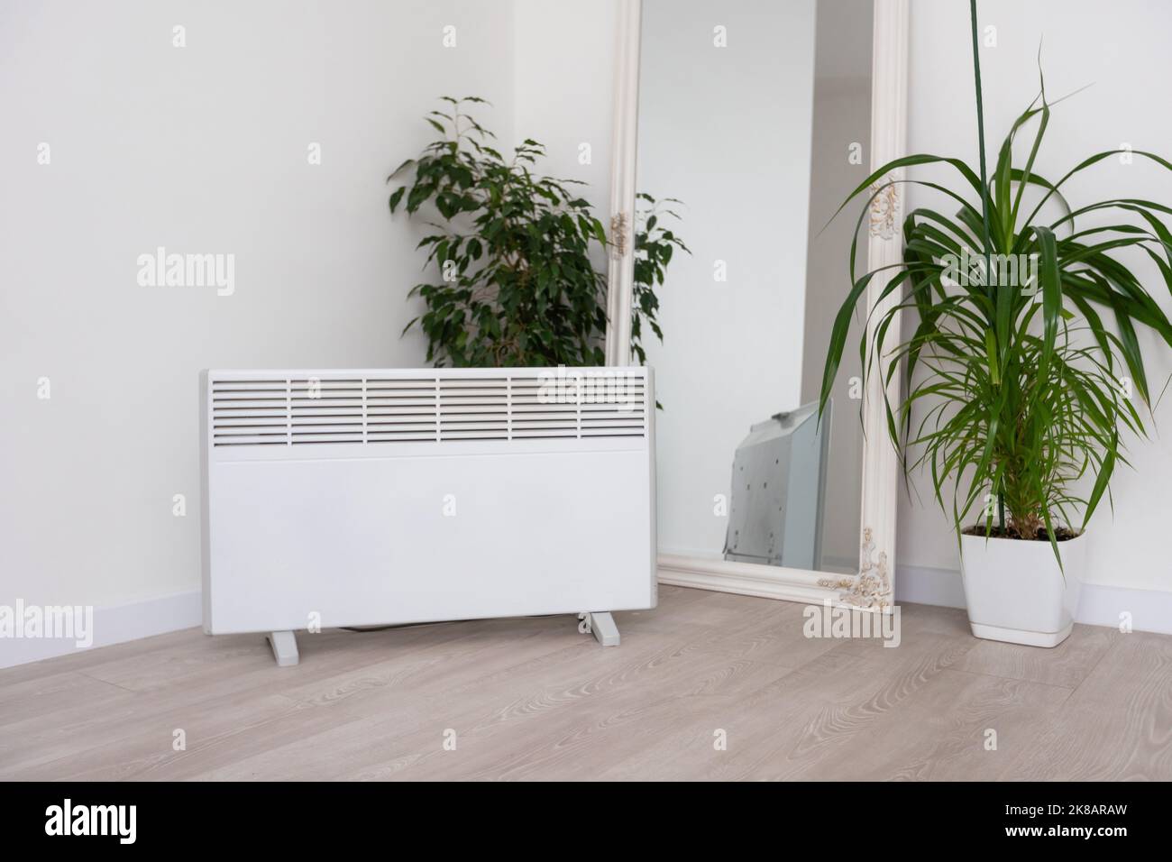 Modern electric heater in stylish room interior Stock Photo - Alamy
