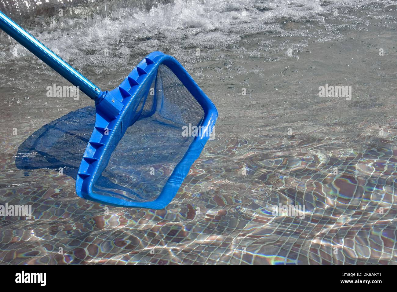 Cleaning pool, city fountain from garbage with special net. Clear water ...