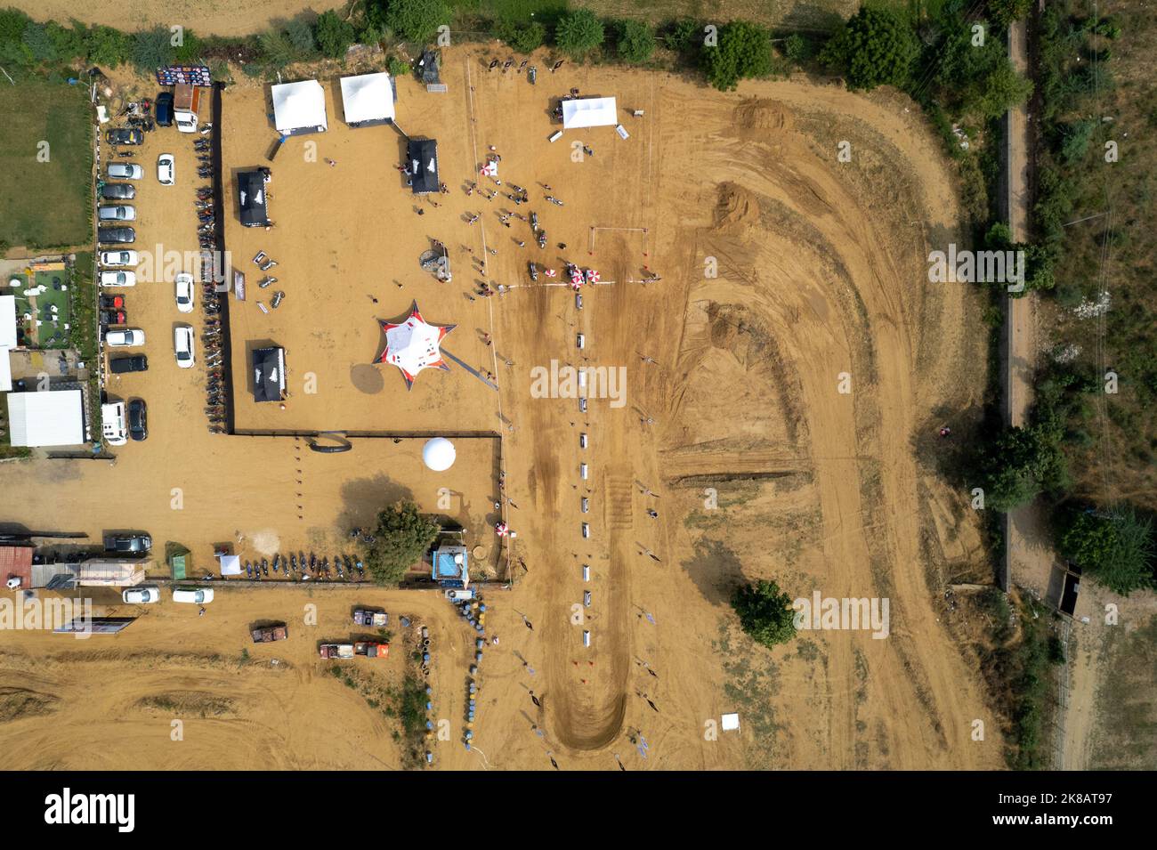 Aerial drone shot from top down showing a dirt off road track for cars ...