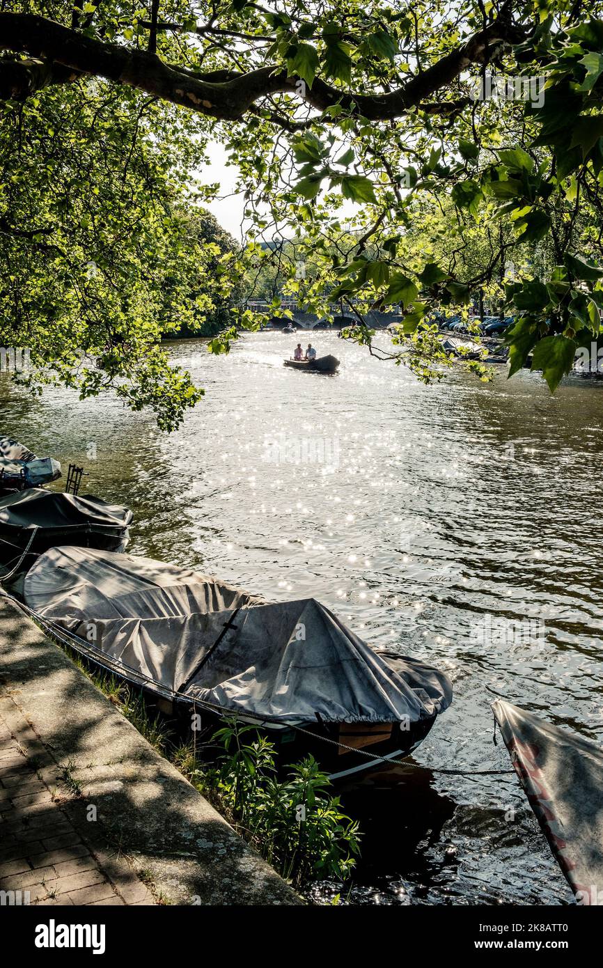 Boating on amsterdam canal, netherlands, Europe Stock Photo - Alamy