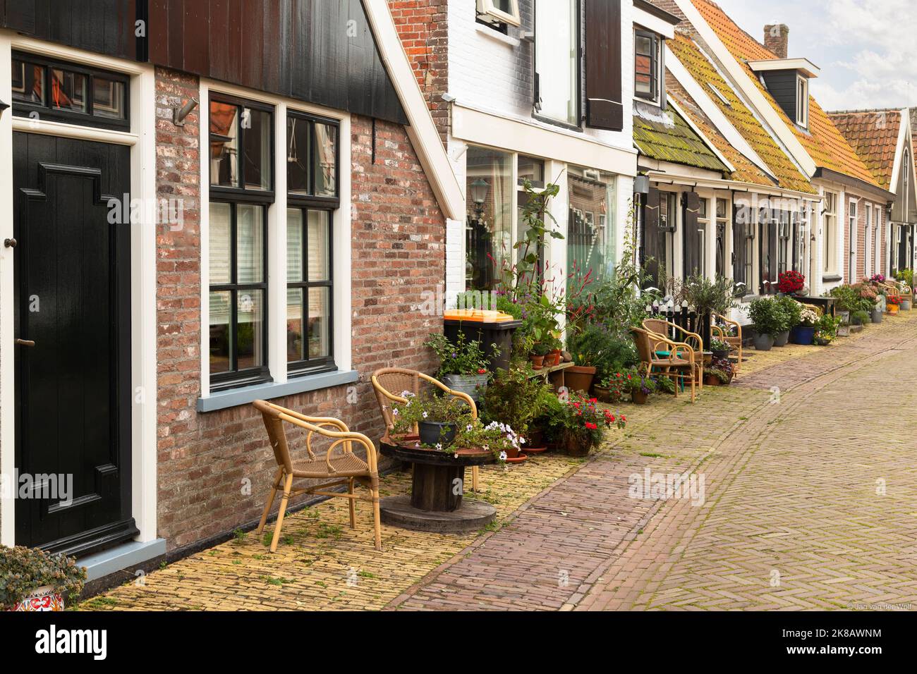 Street gardens with flower pots on a narrow street in the picturesque ...