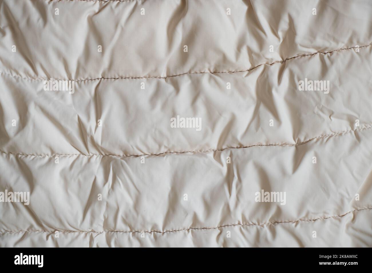 women's padded white soft jacket as background, background of soft ...