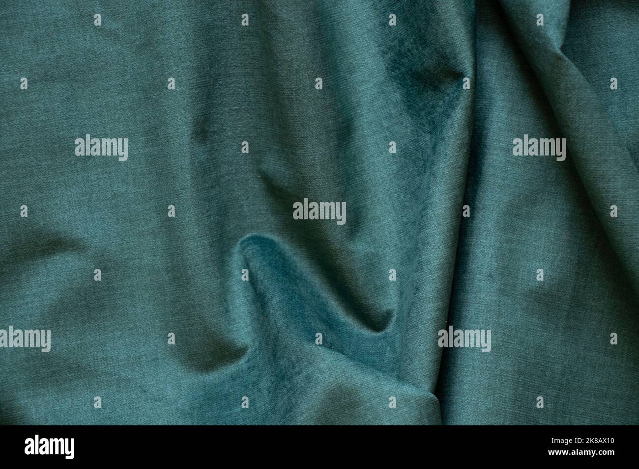 Dark green wrinkled fabric as a background close-up, fashion and trends ...