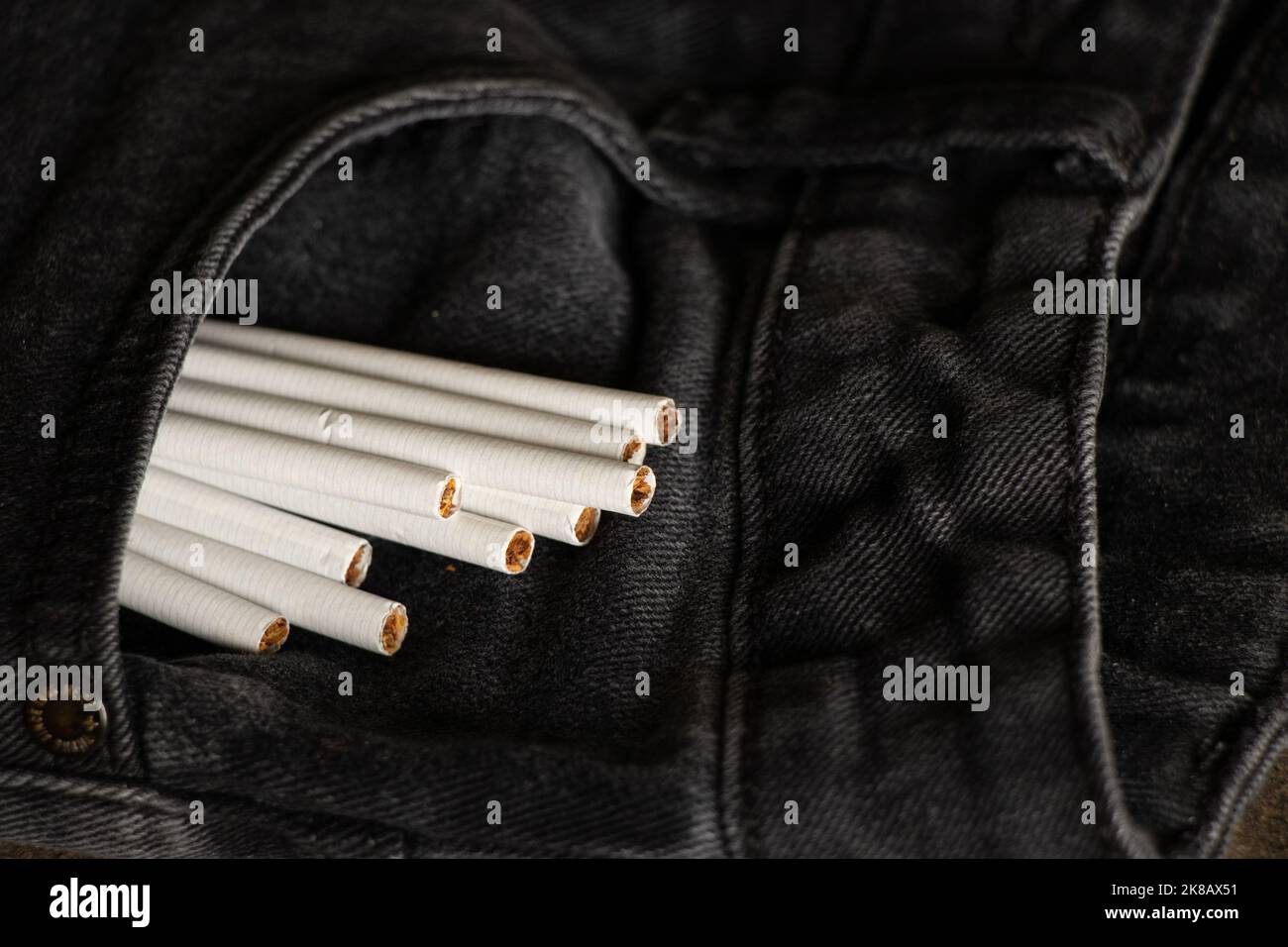 cigarettes in a pocket in gray jeans, cigarette addiction and fashion ...