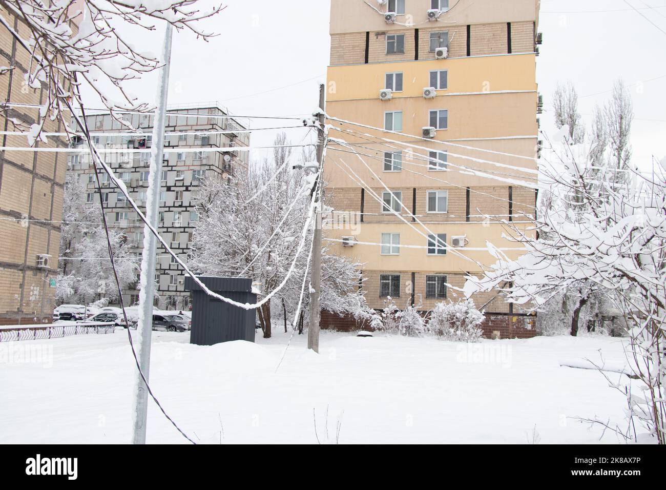 Electric wires in the snow with ice on a pole in a residential area of ...