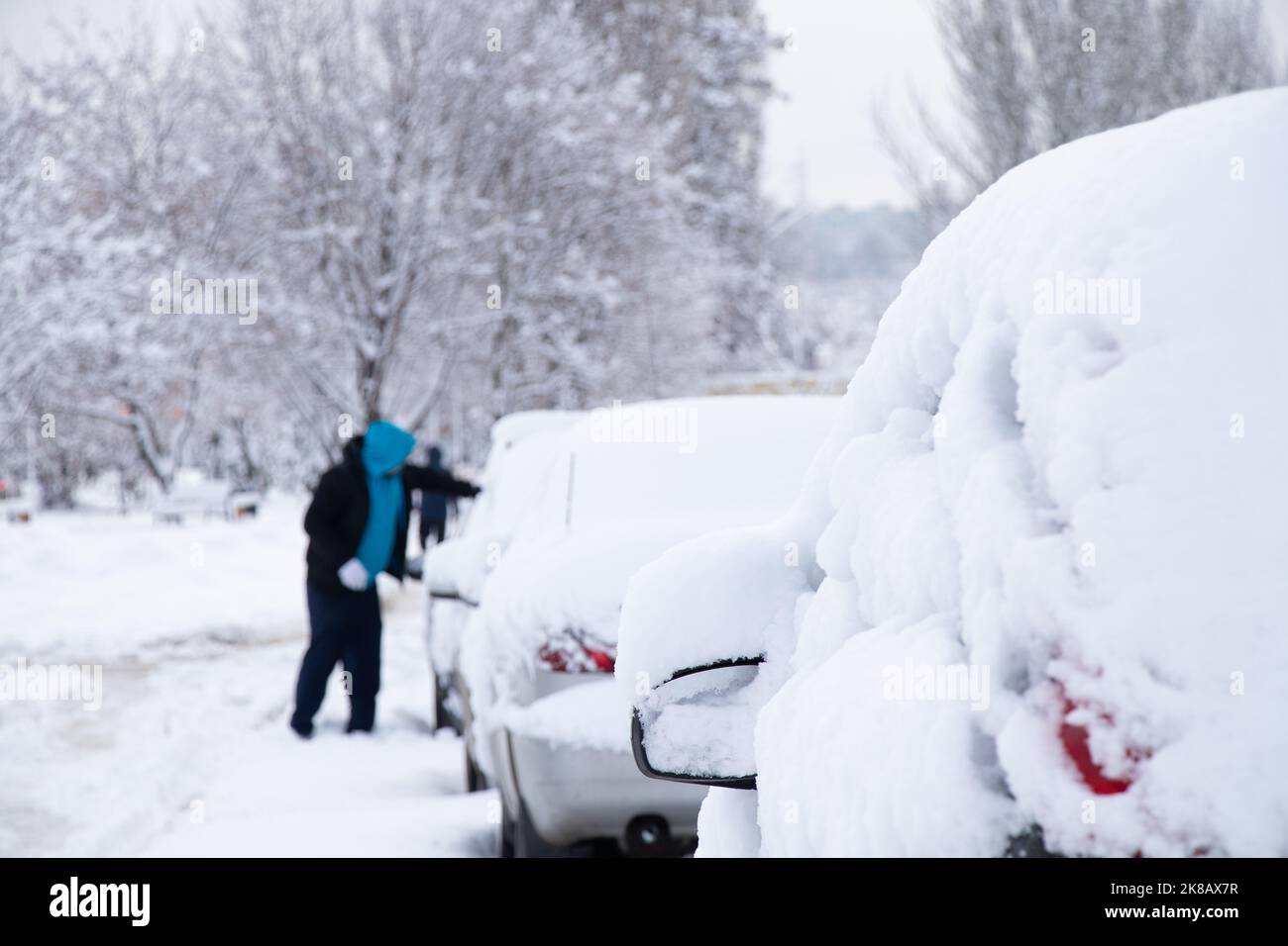 parked cars in the snow in the morning after a blizzard, the driver ...