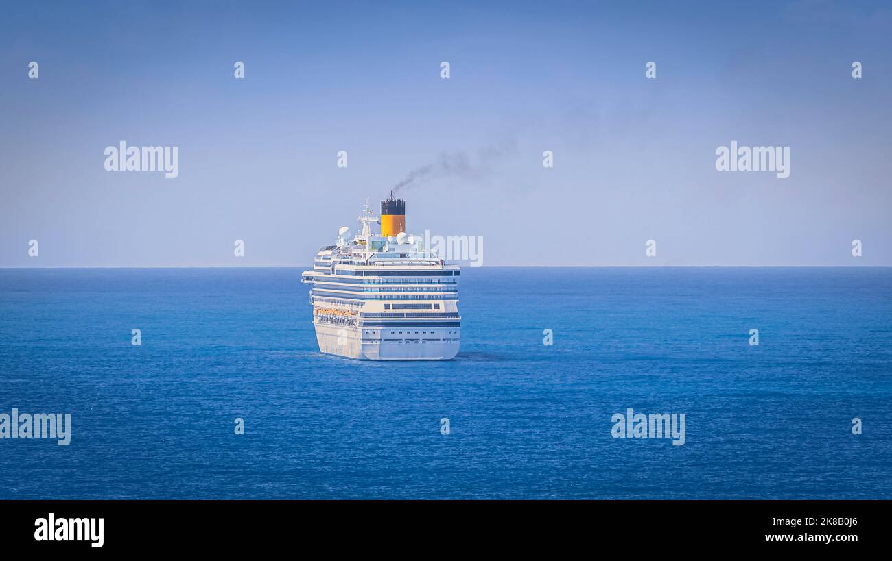 Cruise ship sailing on the blue sea towards the horizon Stock Photo - Alamy