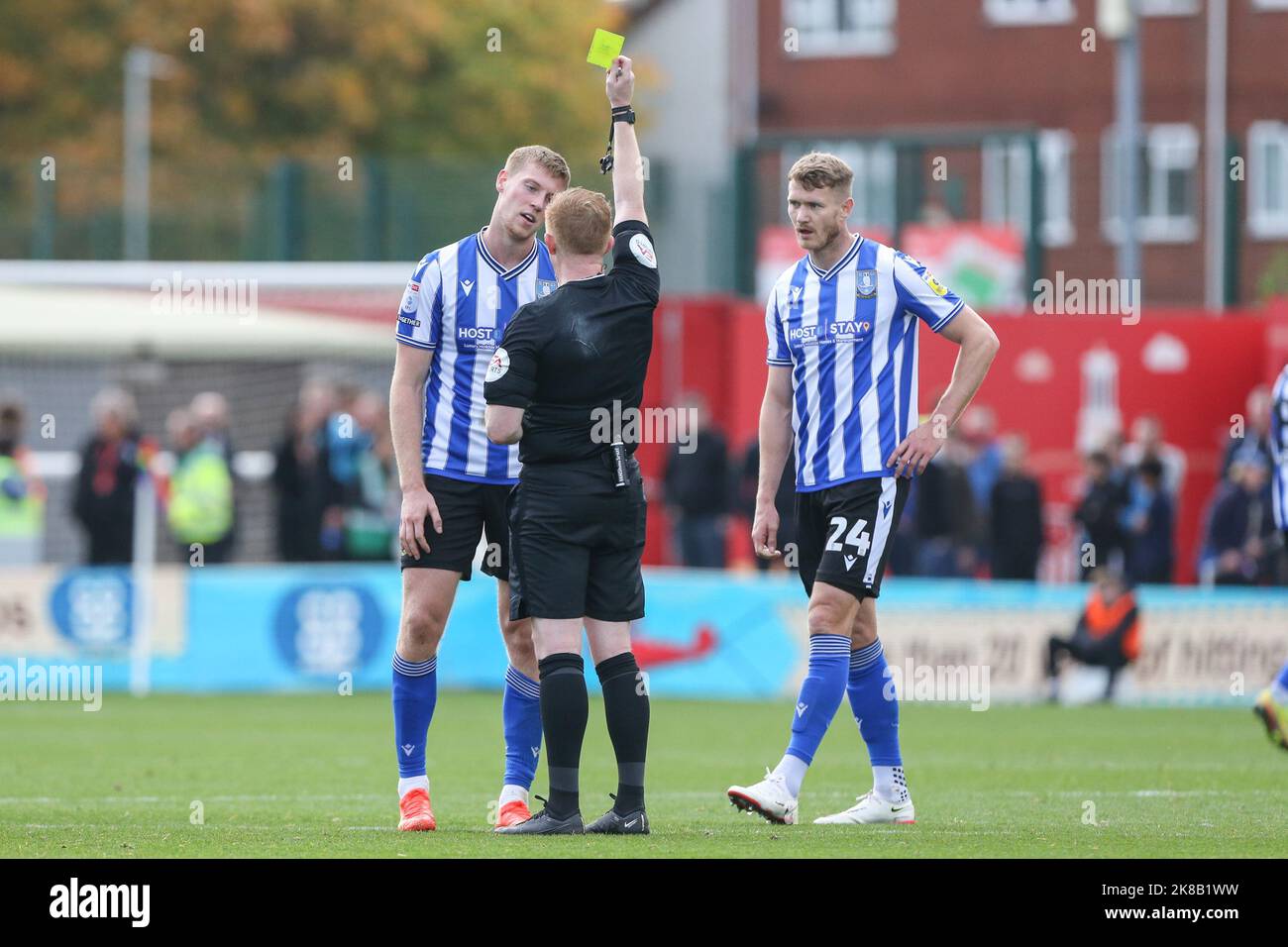 Mark McGuinness #34 of Sheffield Wednesday is shown a yellow card ...