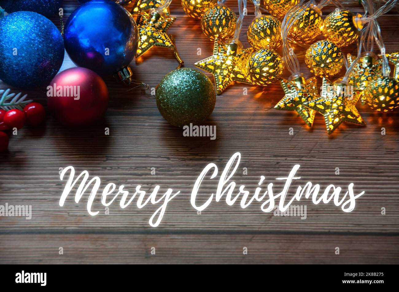 Season's greetings text with Christmas golden balls and starts light ...