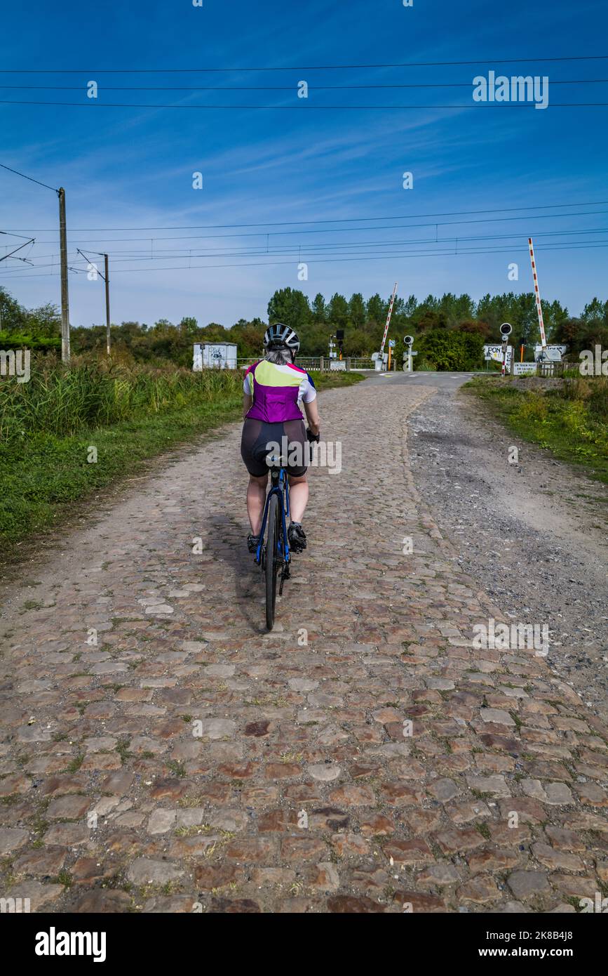 Female road cyclist on the famous sector of Pont Gibus from the classic ...