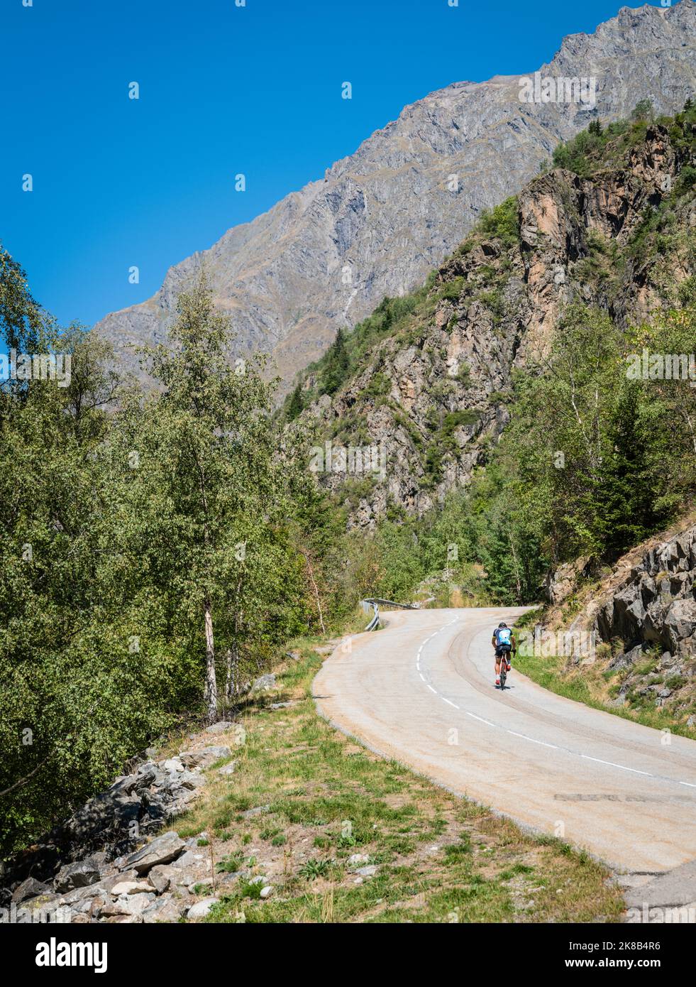 Male road cyclist climbing the mountain road from Saint-Christophe-en ...