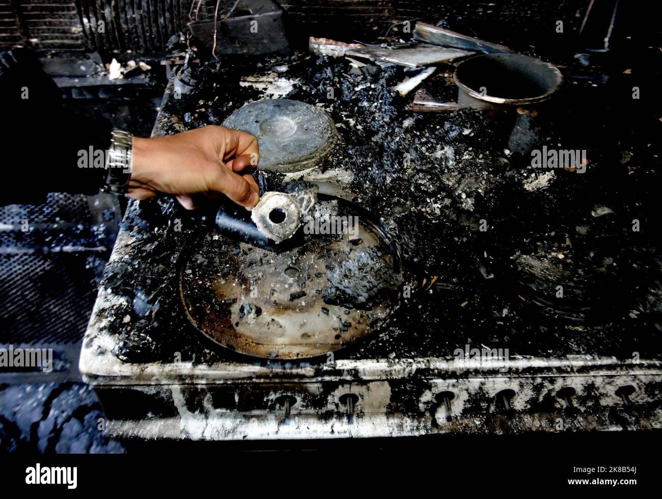 Police forensics technician on site in a burned-out apartment after a ...
