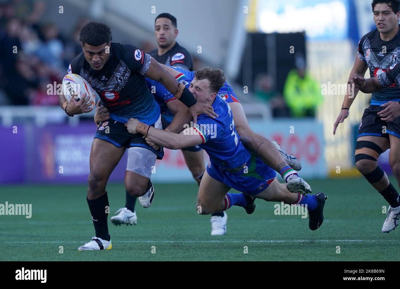 Fiji's Taniela Sadrugu (left) is tackled by Italy's Jack Colovatti ...