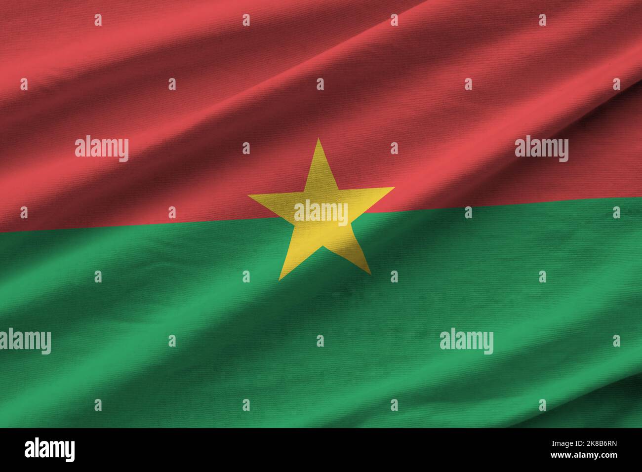 Burkina Faso flag with big folds waving close up under the studio light ...