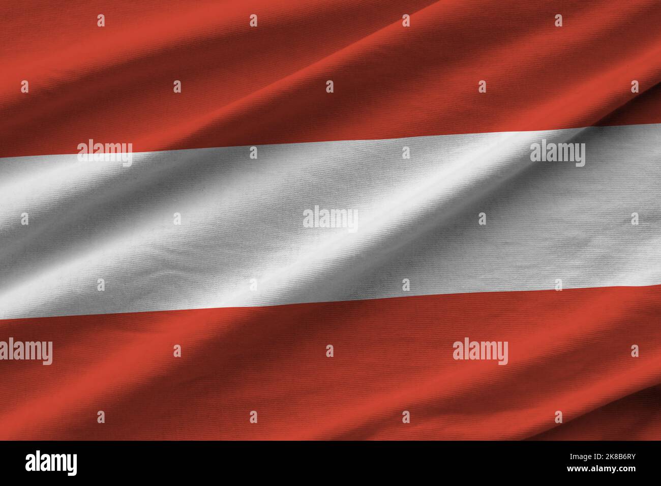 Austria flag with big folds waving close up under the studio light ...