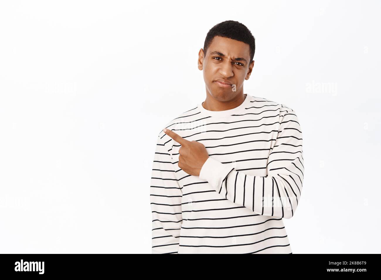 Disappointed african american man, 40 years old, pointing finger left ...