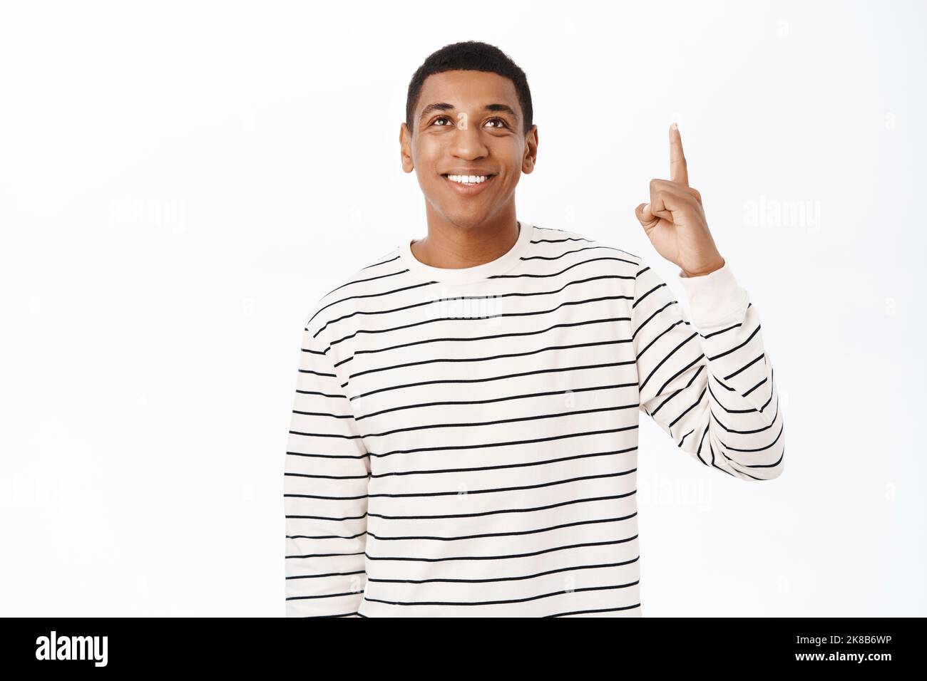 Happy african american man pointing finger up and smiling, showing ...