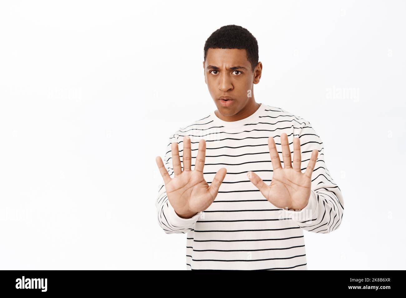 Worried Black man shows stop, reject gesture, prohibit smth, looking ...