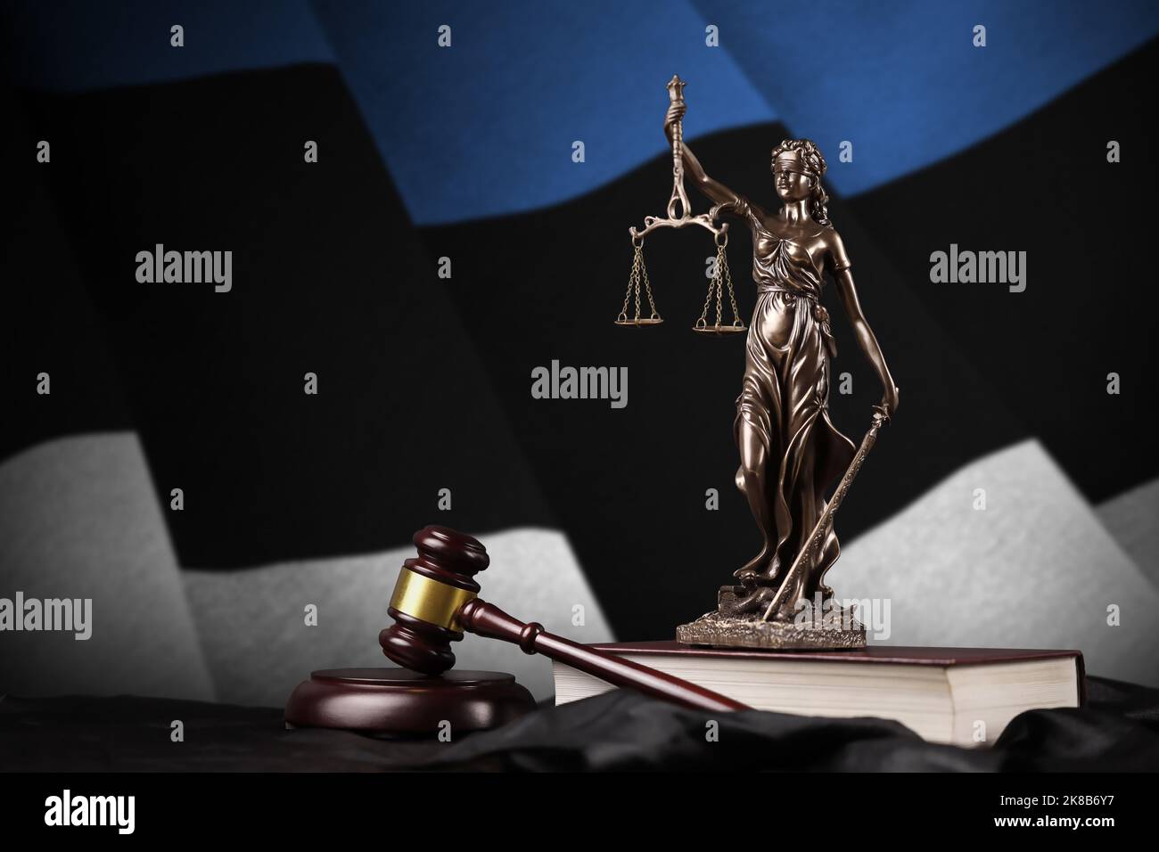Estonia flag with statue of lady justice, constitution and judge hammer ...