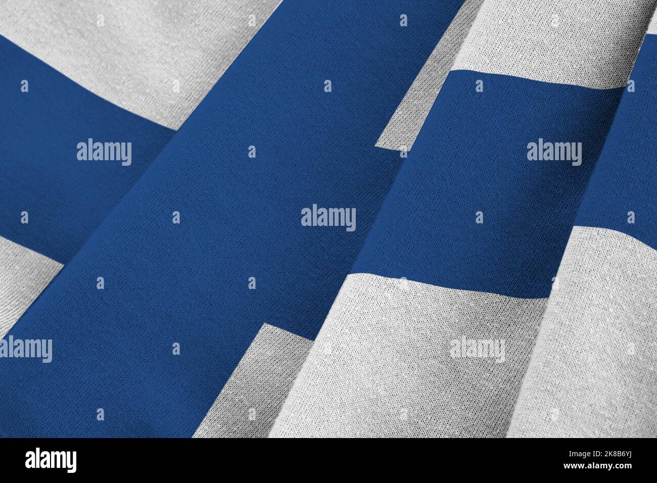 Finland flag with big folds waving close up under the studio light ...