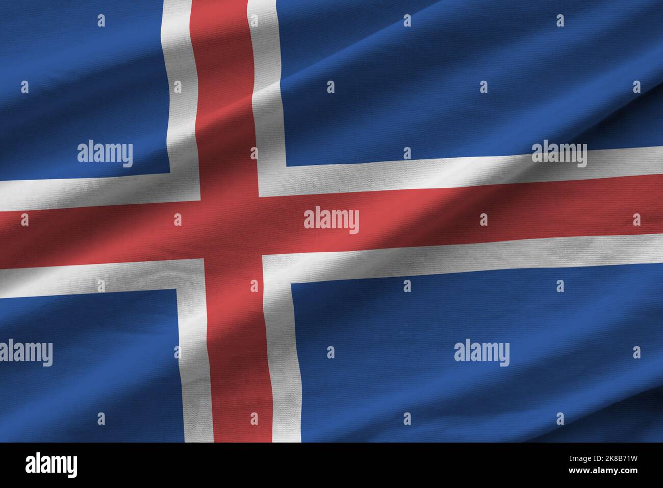 Iceland flag with big folds waving close up under the studio light ...