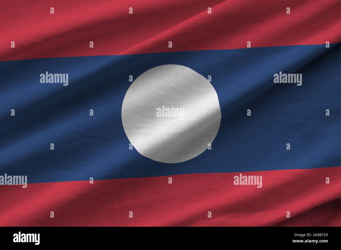 Laos flag with big folds waving close up under the studio light indoors ...