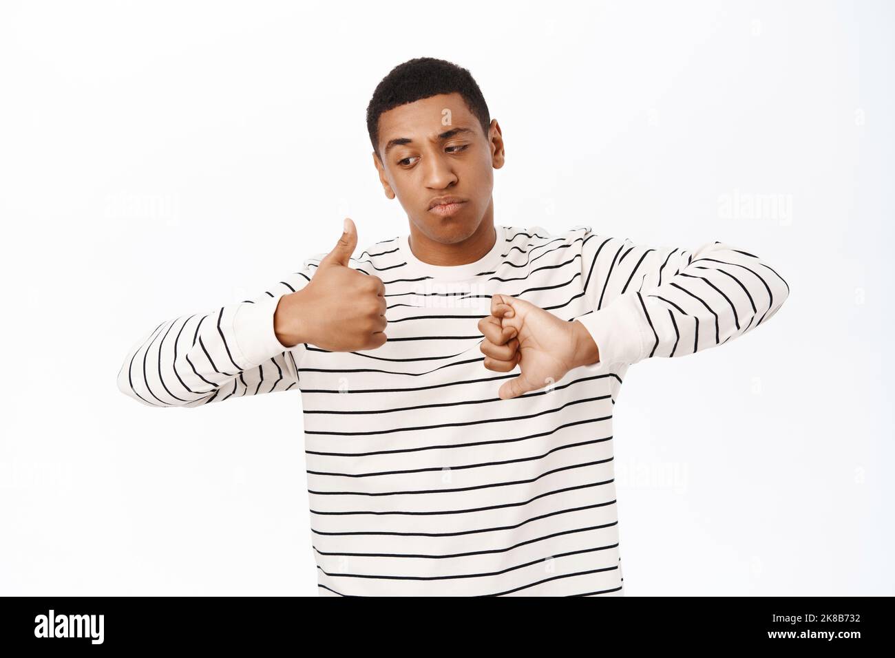Portrait of smiling african american man shows thumbs up and thumbs ...